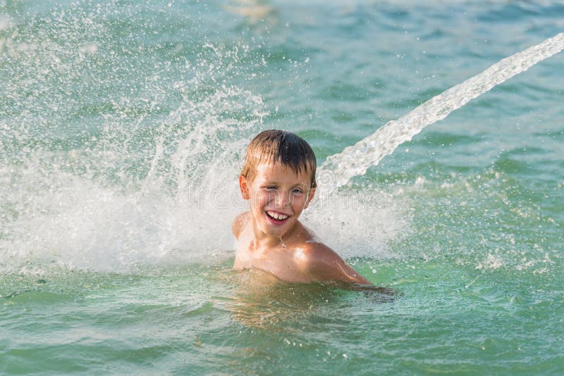 Boy having fun in water stock photo. Image of park, activity - 32836026