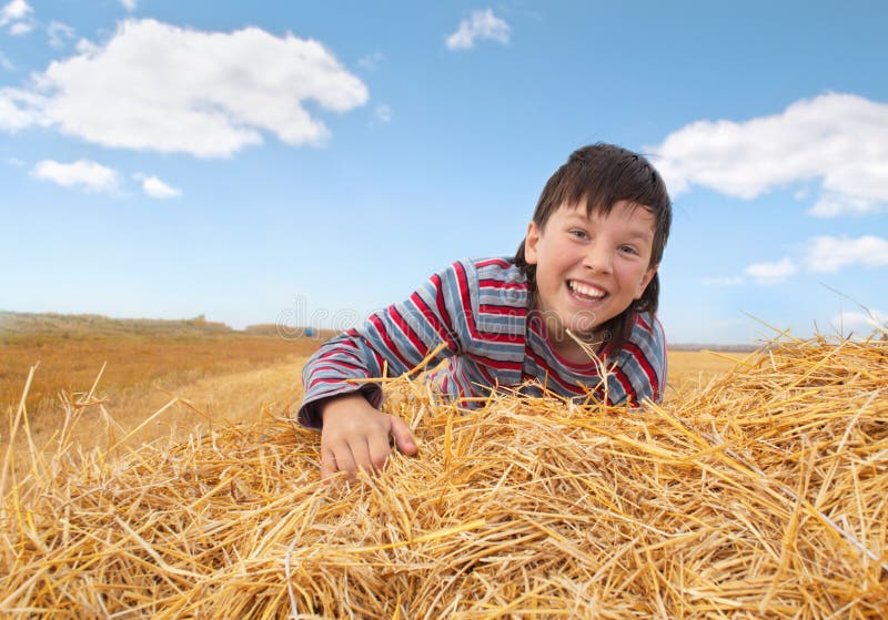 The boy and a haystack stock photo. Image of child, country - 17435148