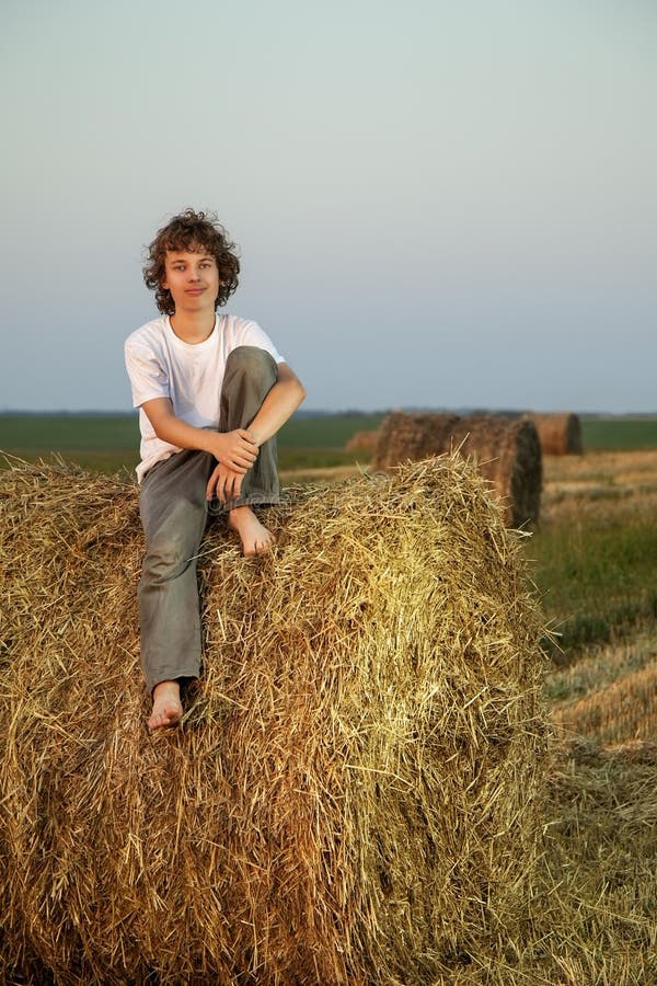 Boy in a Haystack in the Field Stock Image - Image of activity, boys ...