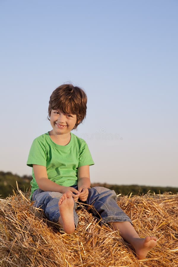 Boy in a Haystack in the Field Stock Image - Image of farm, cloud: 73074989