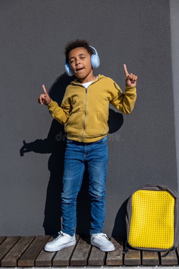 Boy in Headphones Dancing and Looking Excited Stock Photo - Image of ...