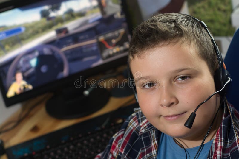 Boy with Headphones is Playing a Computer Game Stock Image - Image of ...