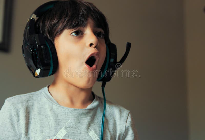 Boy with a Headset Playing a Video Game Stock Image - Image of shocked ...