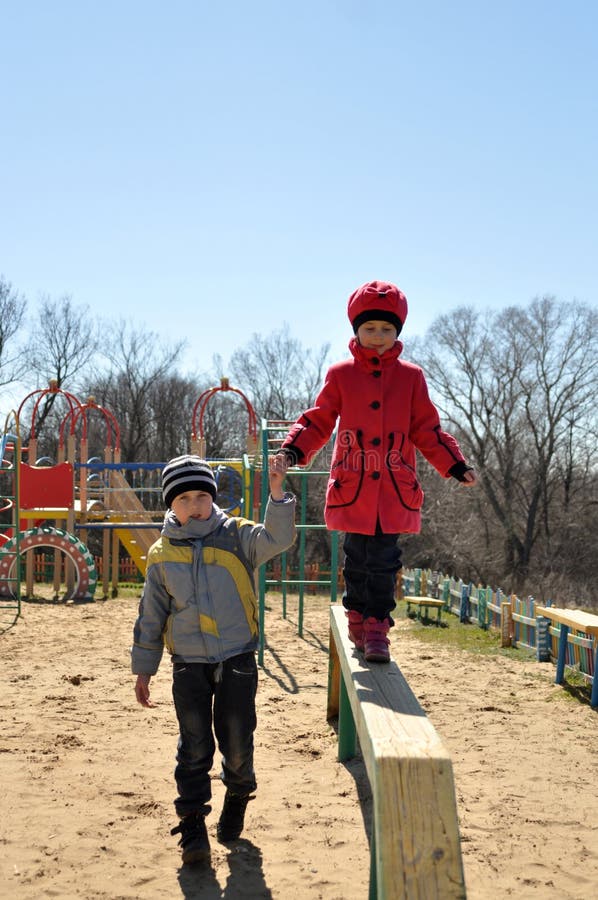 The Boy Helps the Girl To Pass on Log Stock Image - Image of childrens ...