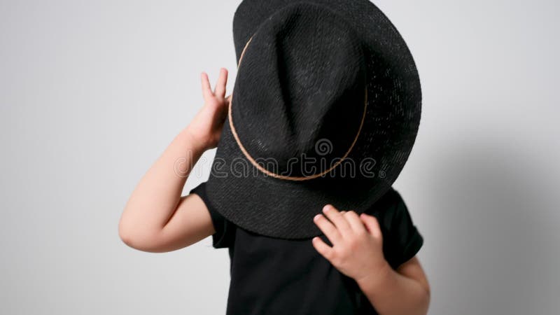 Boy Hid His Face Behind a Black Hat while Standing Stock Video - Video ...