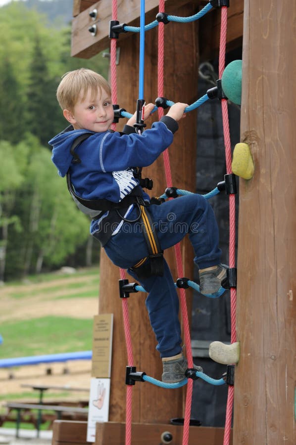 Young Boy Navigating High Rope Course at Outdoor Playground Stock Image ...