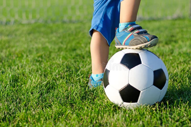 Boy with His Foot on a Soccer Ball Stock Image - Image of outdoors ...