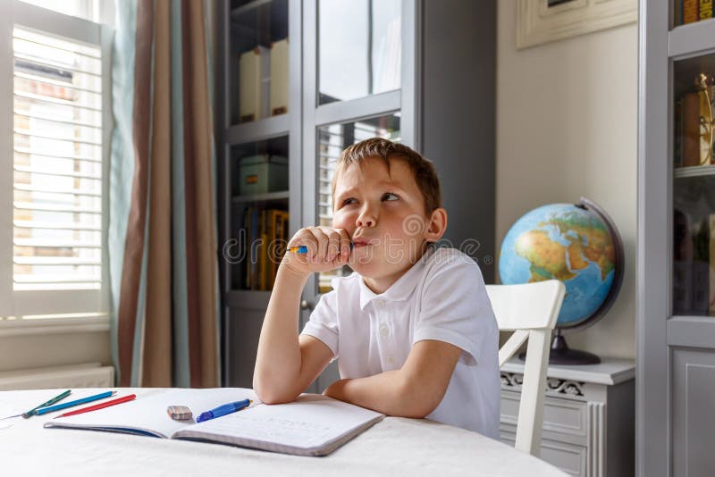 Boy at his homework stock photo. Image of books, geotagged - 69996556