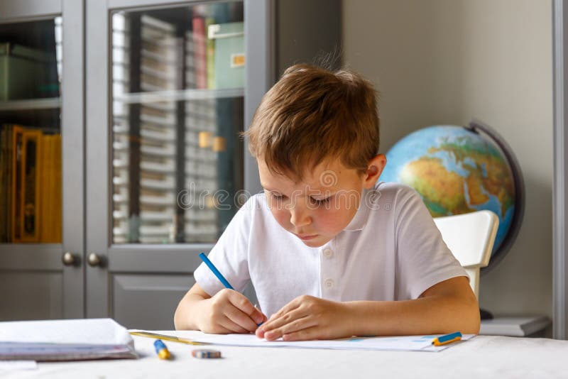 Boy at his homework stock image. Image of writing, notepad - 69996561