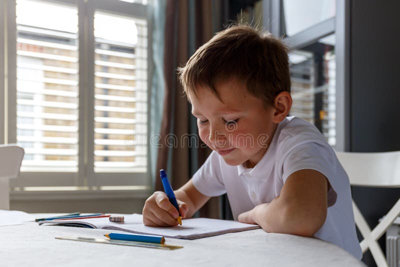 Boy at his homework stock photo. Image of frame, full - 69996578