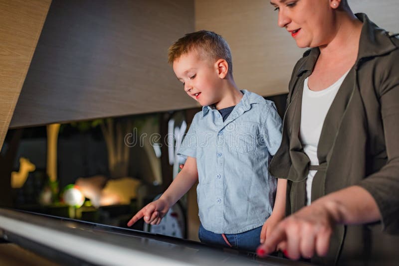 Boy with His Mom in a Museum, Watching a Touch Screen Display Stock ...