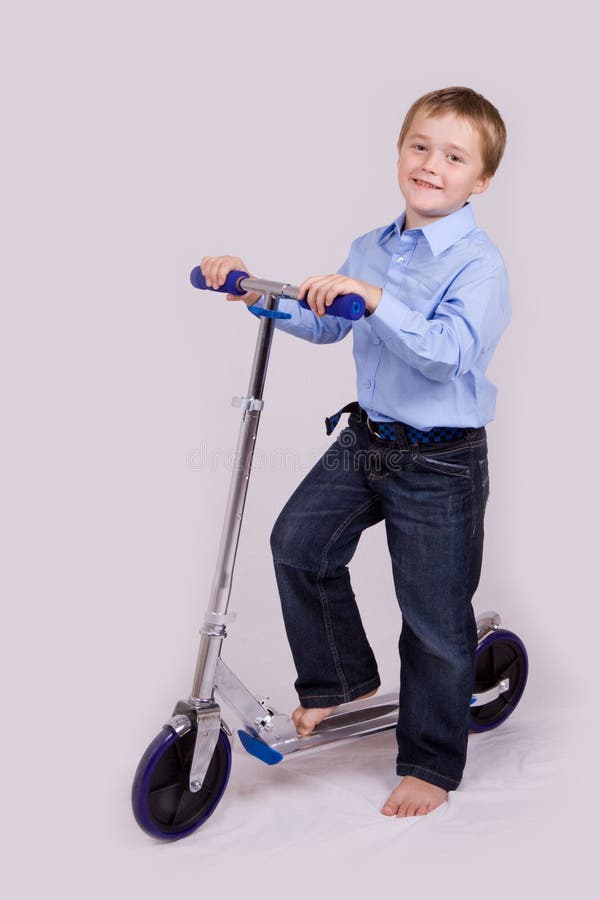Boy on his scooter stock photo. Image of activity, riding - 11660504