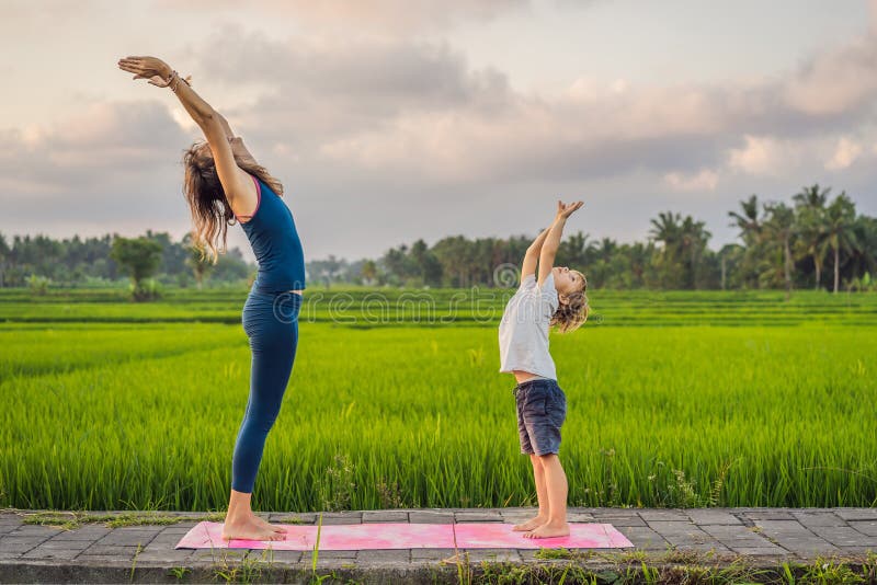 Boy and His Yoga Teacher Doing Yoga in a Rice Field BANNER, LONG FORMAT ...