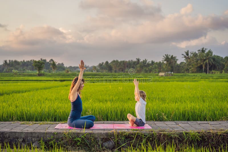 Boy and His Yoga Teacher Doing Yoga in a Rice Field Stock Photo - Image ...