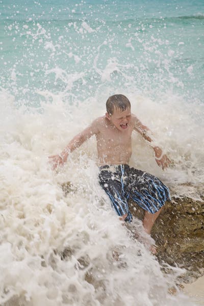 Boy hit by wave stock image. Image of ocean, surprised - 11038731