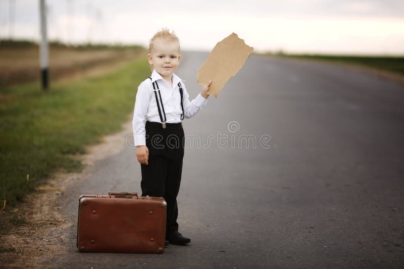 Boy hitch hiking at road stock photo. Image of little - 35007096