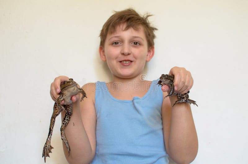 Boy Holding a Big Toad in His Hands. Two Frogs Stock Photo - Image of ...