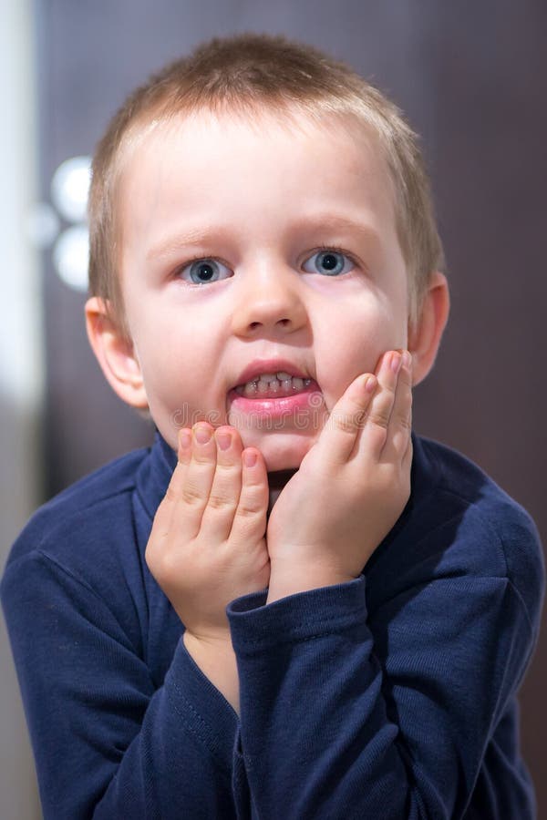 Boy holding the face stock photo. Image of young, adorable - 63077866