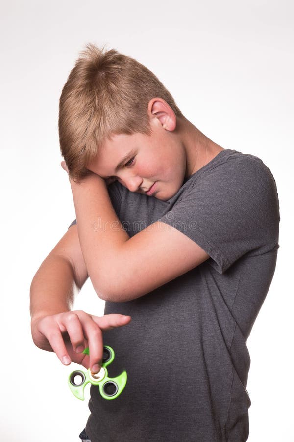 Boy holding fidget spinner stock photo. Image of front - 92620668