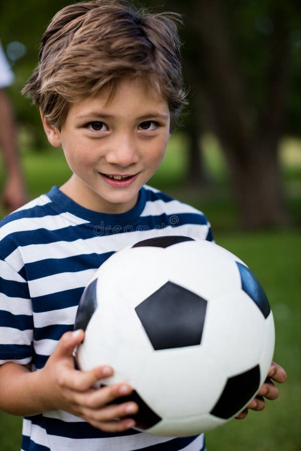 Boy Playing Football in Park Stock Image - Image of male, summer: 95446307