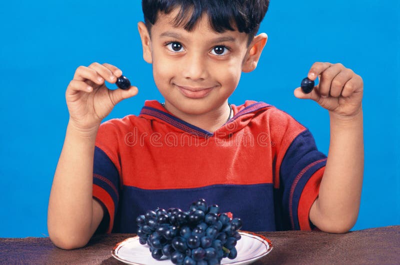 Boy Holding Grapes in Hand India MR#152 Editorial Photography - Image ...