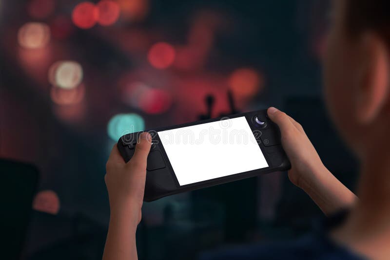 Boy Holding a Handheld Gaming Console Playing a Game in Low Light ...