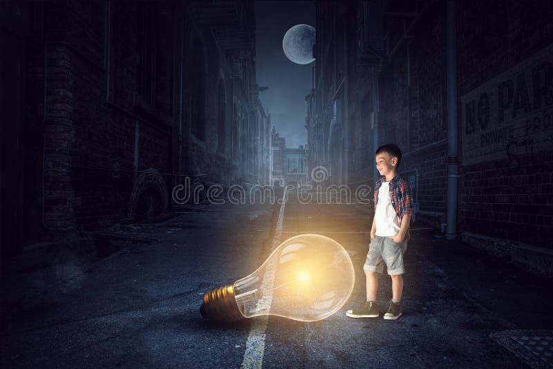 Boy holding a light bulb stock image. Image of light - 181121415