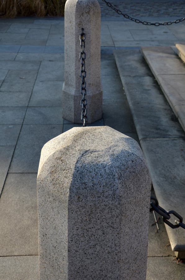Boy Holding a Massive Stone Pillar with a Chain on the Square ...