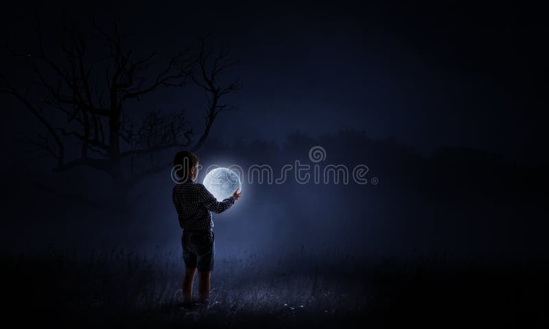 Boy holding moon at night stock photo. Image of alone - 191358194