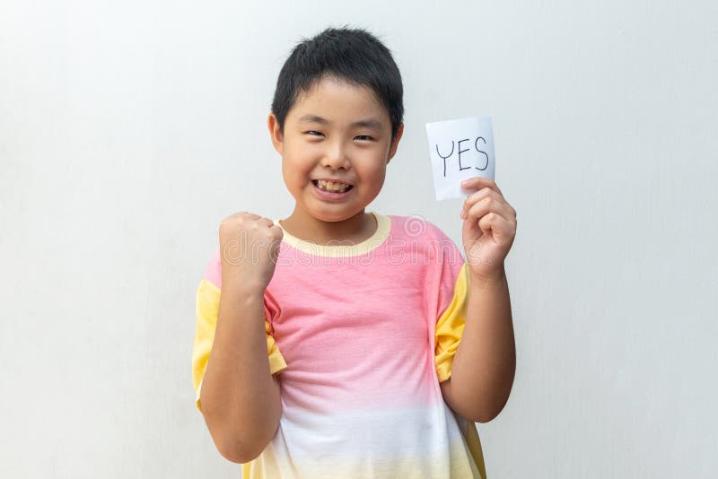Boy holding paper with Yes stock photo. Image of select - 181010074