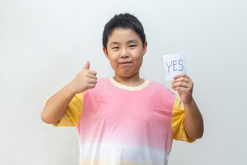 Boy holding paper with Yes stock image. Image of message - 181010077