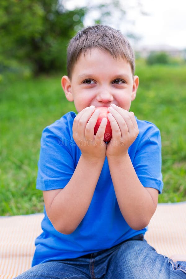 Boy Holding Red Apple by Two Hands Stock Image - Image of eating ...