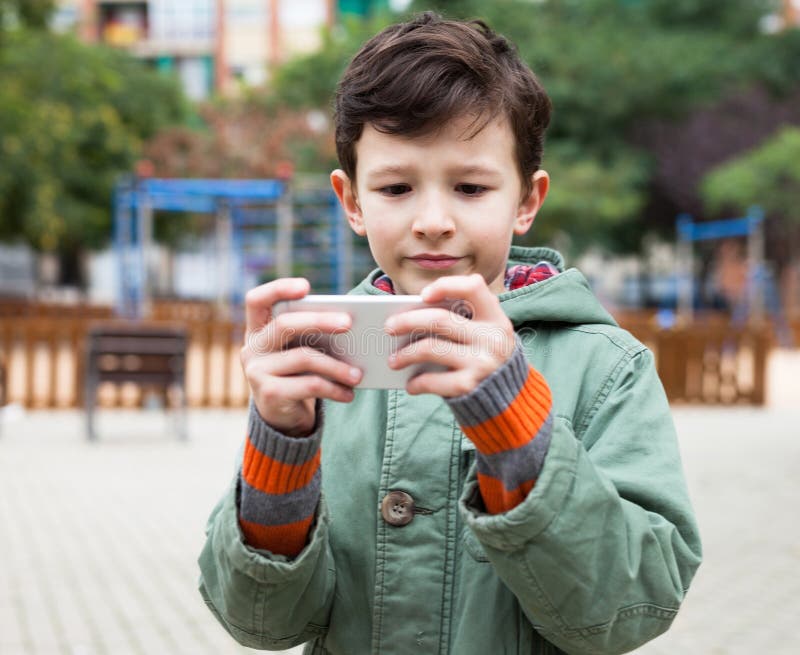 Boy Holding Smartphone Outdoors in Autumn Stock Photo - Image of ...