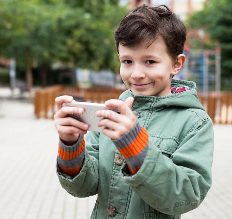Boy Holding Smartphone Outdoors in Autumn Stock Image - Image of ...