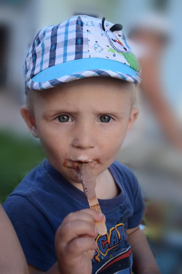 The Boy is Holding a Stick of Chocolate Ice Cream Stock Image - Image ...