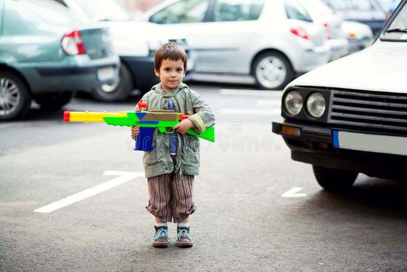 Boy holding toy rifle stock image. Image of young, standing - 24791753