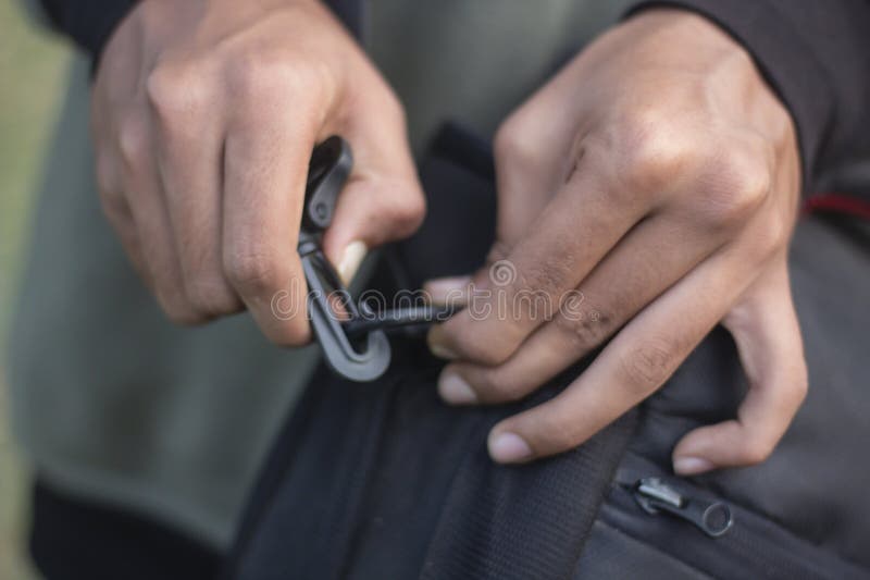 A Boy Holds His Hand on a Black Bag Hook Stock Photo - Image of body ...