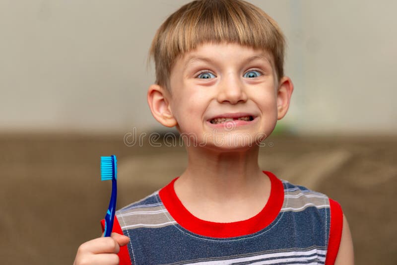 The Boy Holds a Toothbrush in His Hand Showing Clean Teeth Stock Image ...