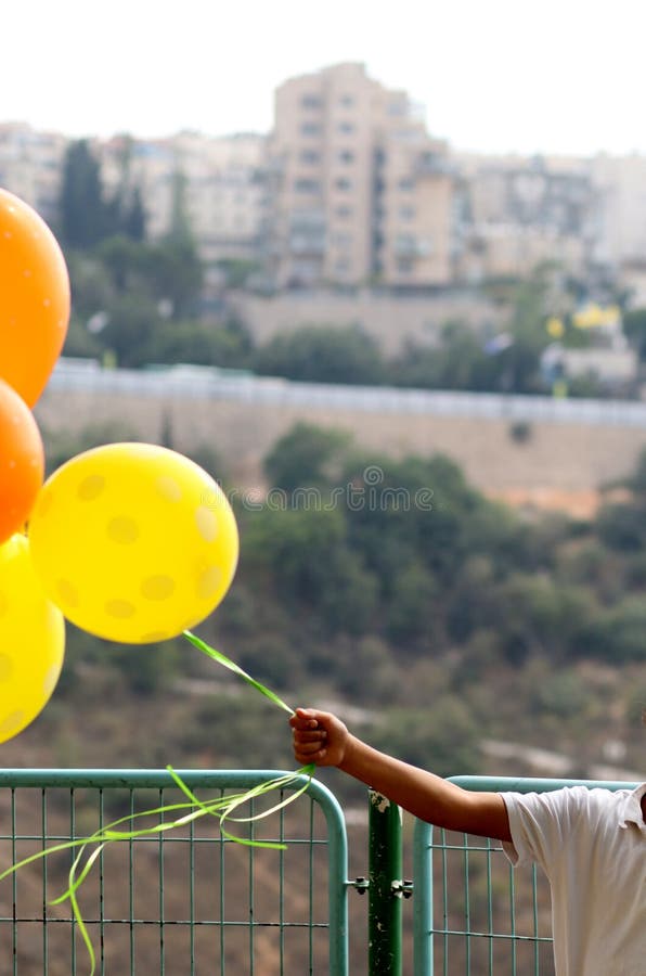 A Boy Holds Yellow and Orange Balloons Stock Photo - Image of childhood ...