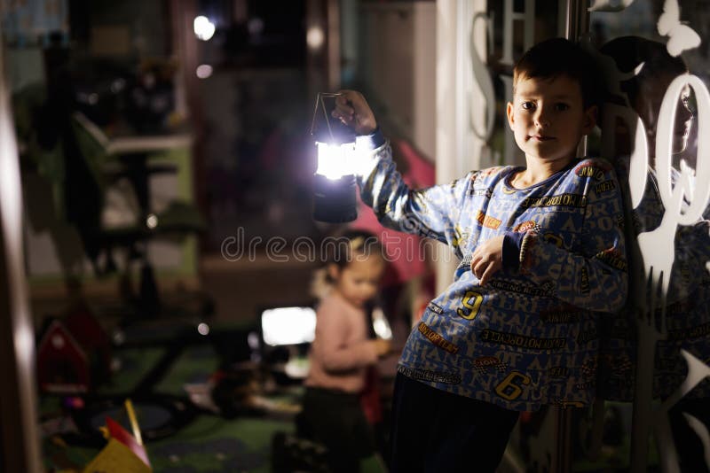 Boy at Home during a Blackout Using Flashlight Lantern Stock Photo ...