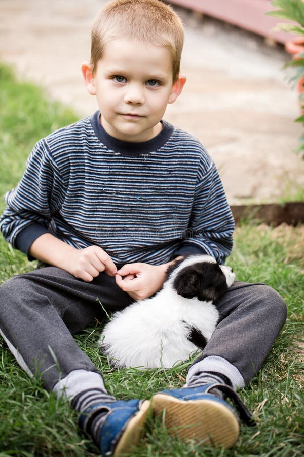 Boy with home pet stock image. Image of domestic, lawn - 166229693