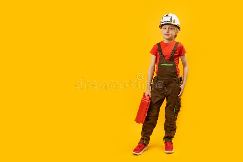 Boy Imitates Worker or Construction Worker. Child in Work Overalls and ...