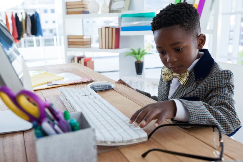 Boy Imitating As Businessman Using Computer at Desk Stock Image - Image ...