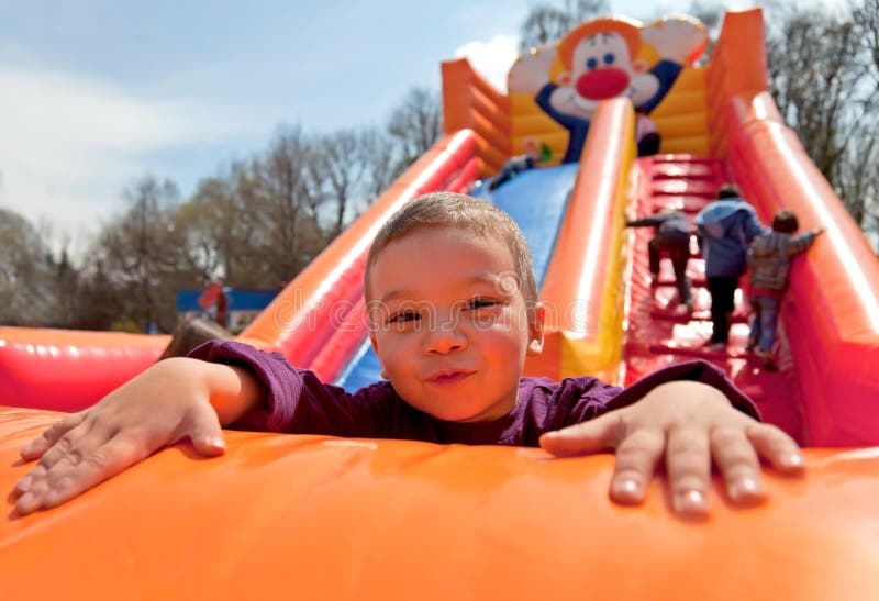 Boy inflatable slide stock photo. Image of smiling, slide - 23460484