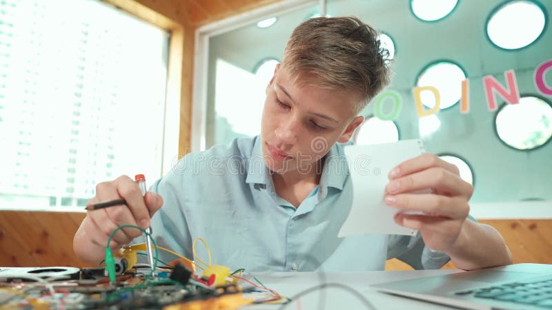 Boy Inspect or Learning To Use Electronic Tool while Taking a Note ...