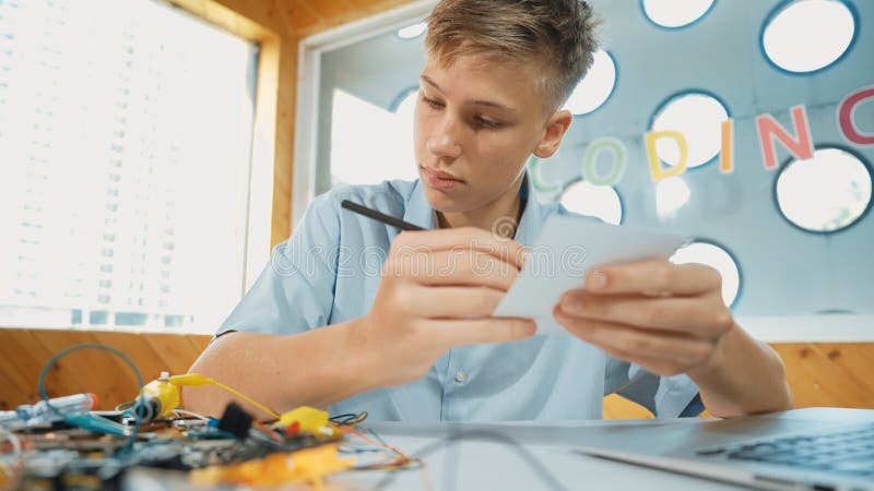 Boy Inspect or Learning To Use Electronic Tool while Taking a Note ...
