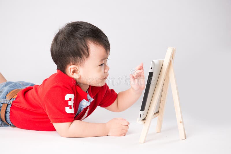 Baby with Ipad stock image. Image of infant, games, asian - 27396297