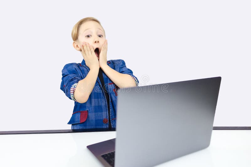 Boy in the Jacket is Surprised Sitting at the Computer Stock Photo ...