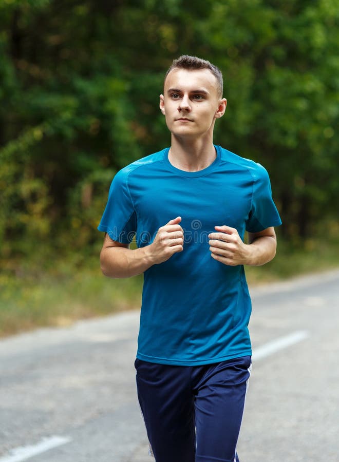 Boy jogging through forest stock photo. Image of energy - 85221328