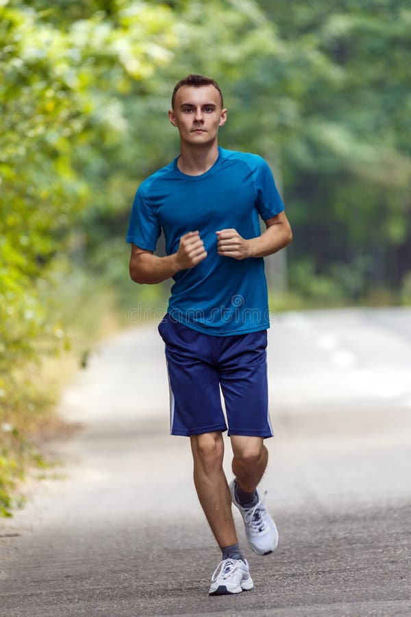 Boy jogging through forest stock photo. Image of fitness - 85247592